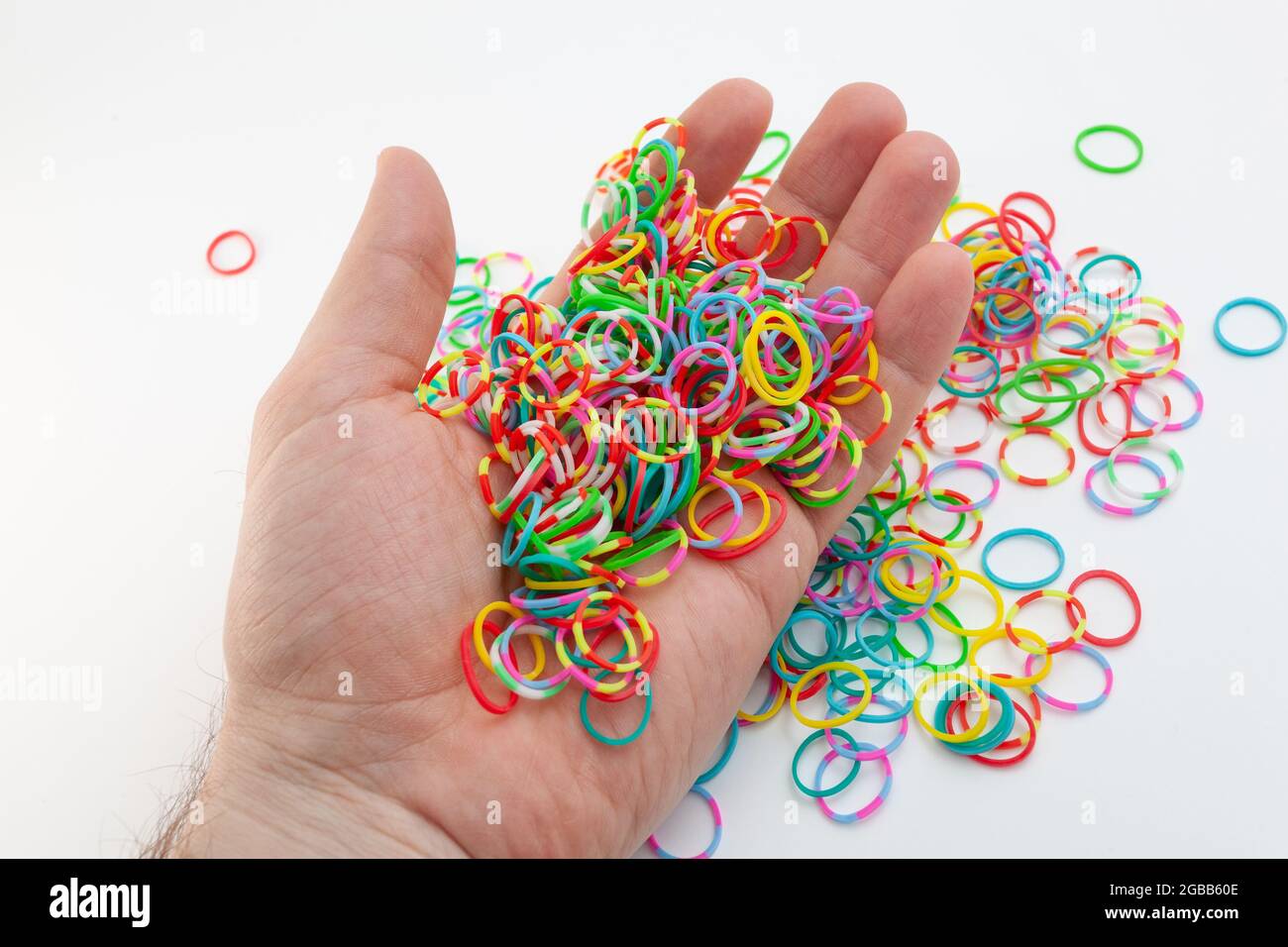 Isolated Color rubber band in hand Stock Photo - Alamy