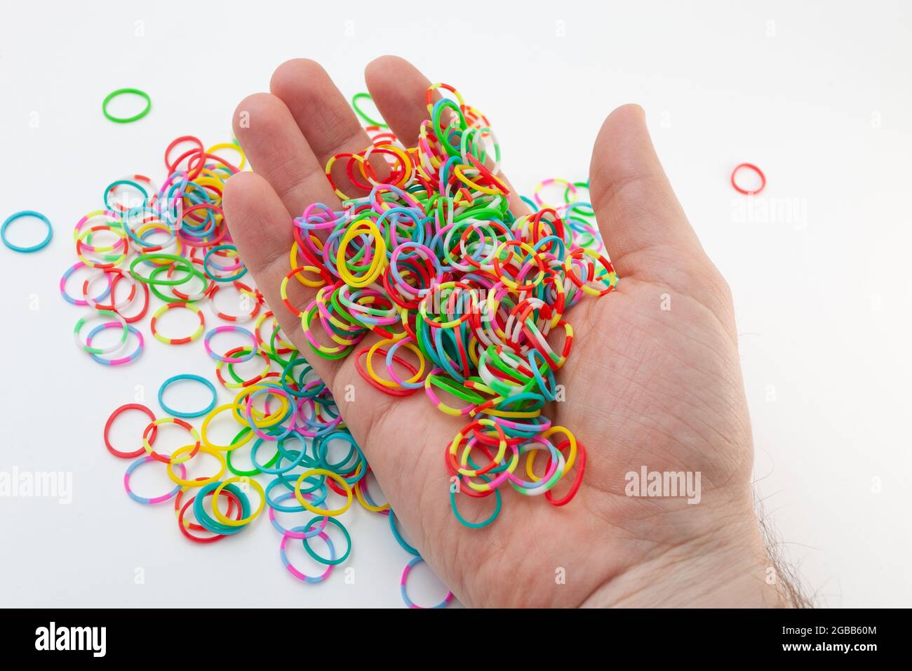 Isolated Color rubber band in hand Stock Photo - Alamy