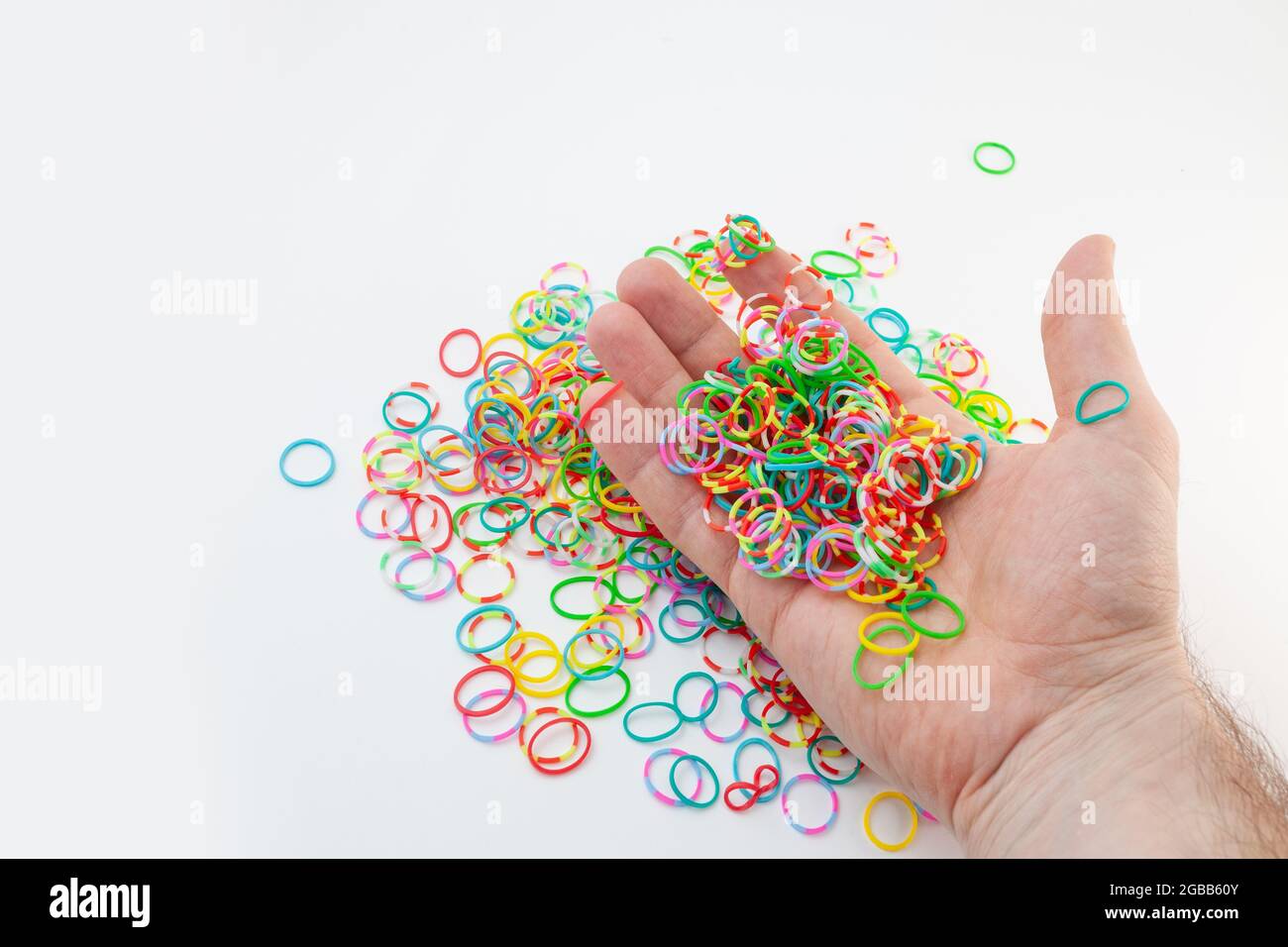 Isolated Color rubber band in hand Stock Photo - Alamy