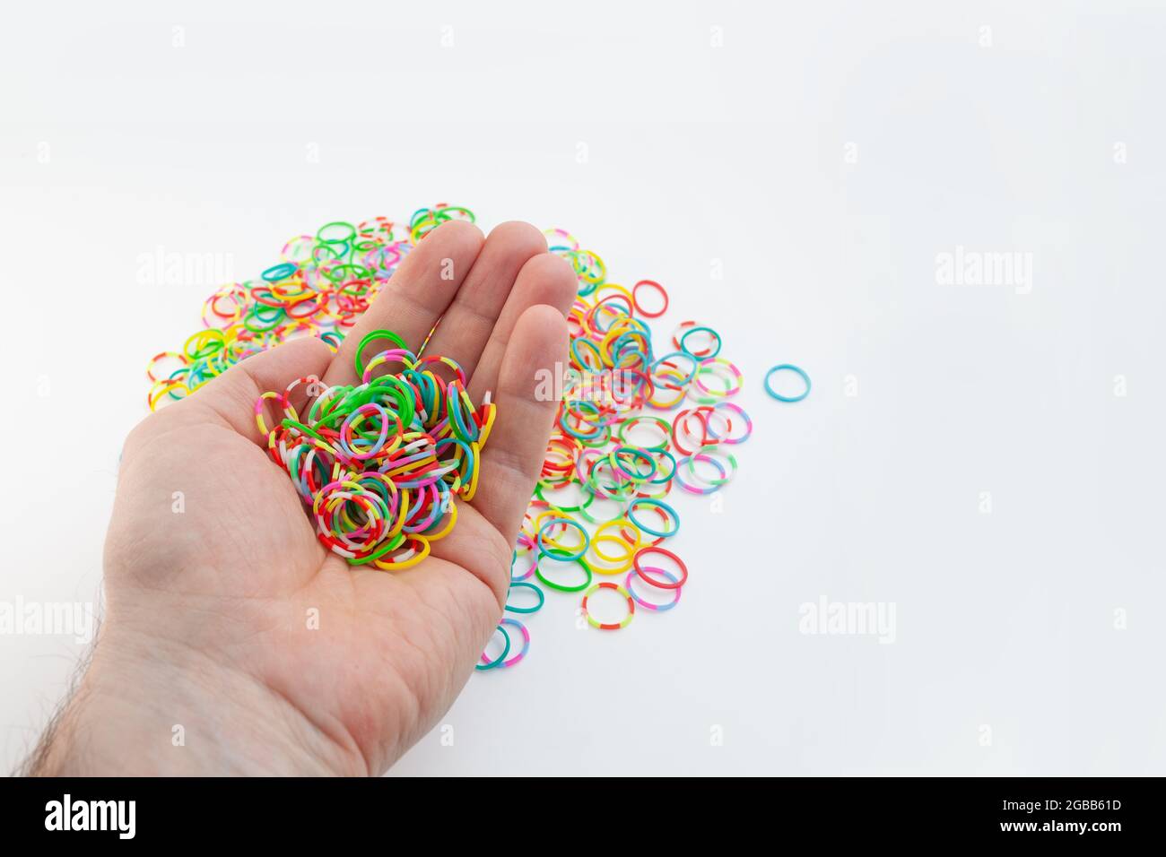 Isolated Color rubber band in hand Stock Photo - Alamy