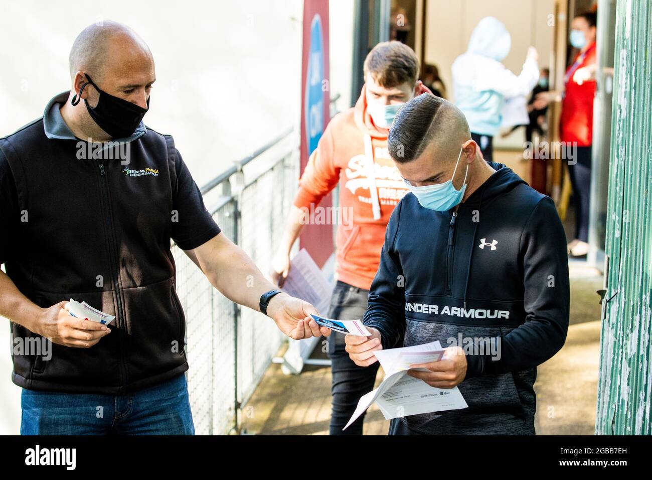 Feile an Phobail organiser Kevin Gamble (left) giving Peter Berne ...