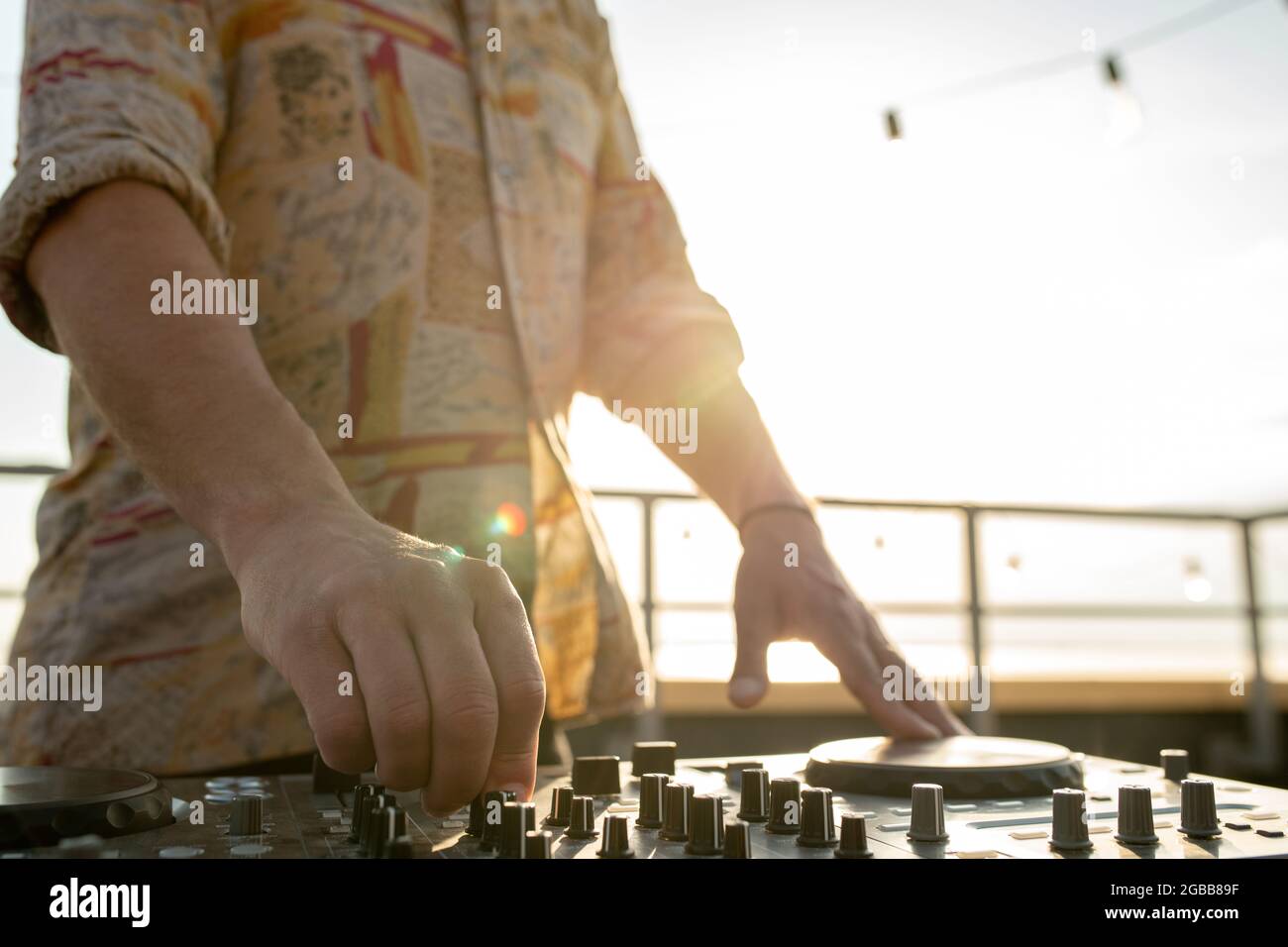 Hand of young man mixing sounds by soundboard at rooftop party Stock ...