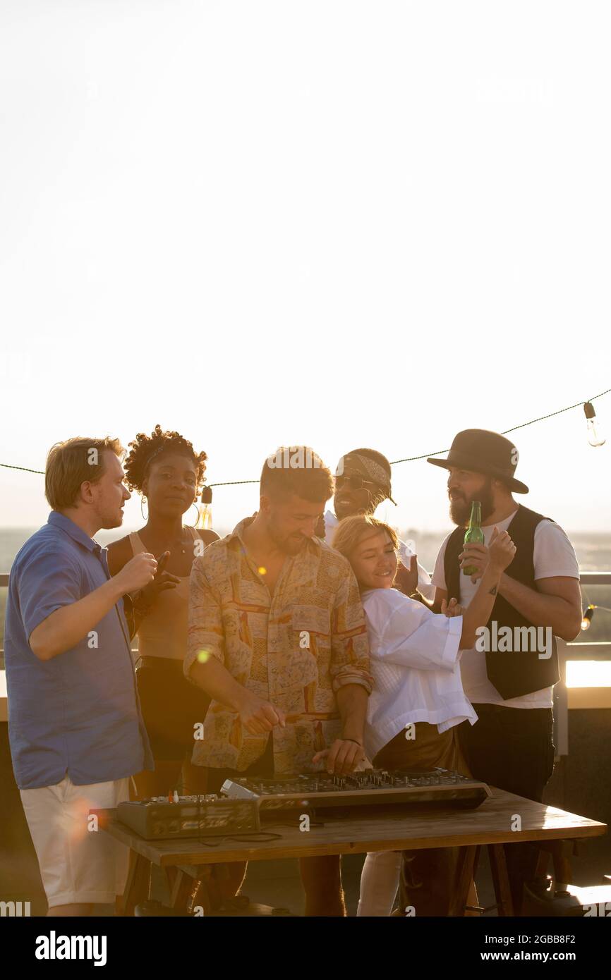 Group of happy young people dancing and having fun during rooftop party ...