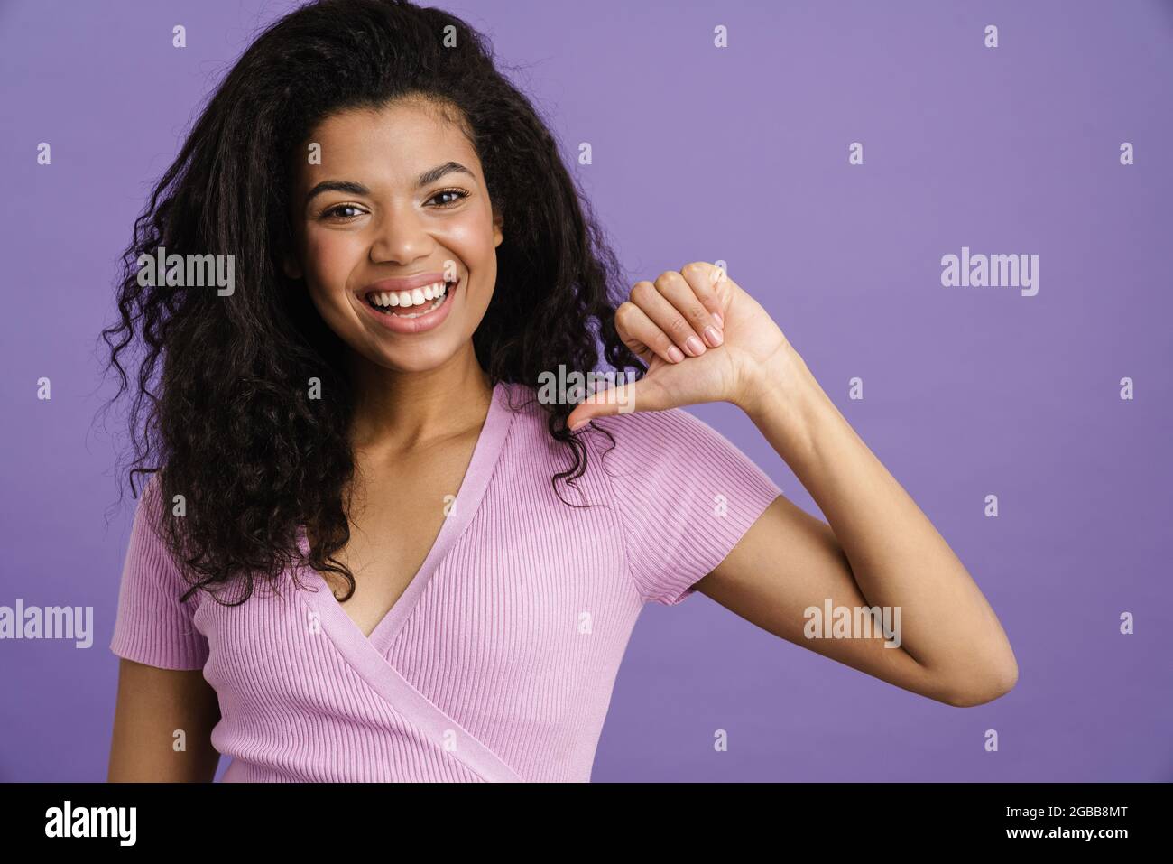 Young Black Woman Laughing While Pointing Finger At Herself Isolated