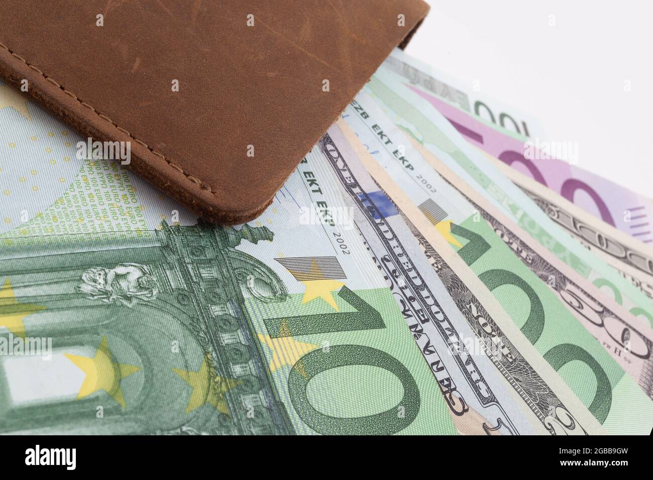 wallet with euro and dollars sticking out of it, isolated Stock Photo ...