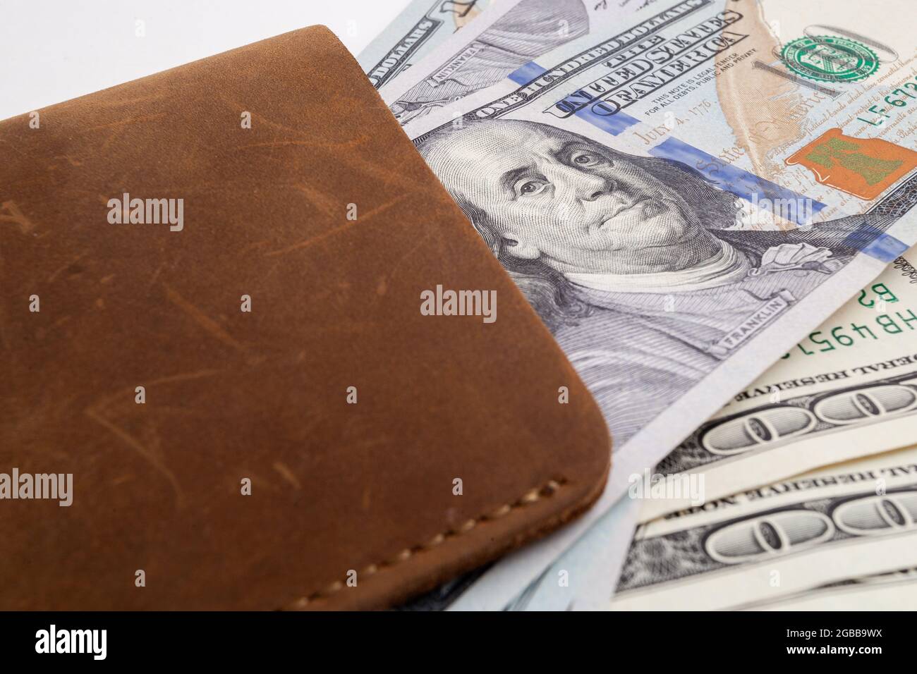 wallet with dollars sticking out of it Stock Photo - Alamy