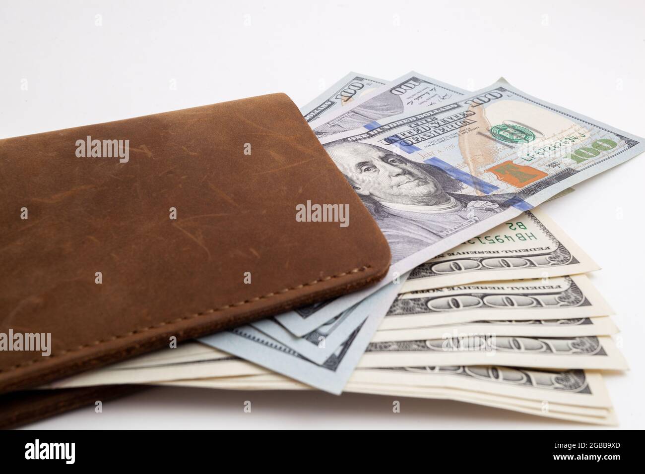 wallet with dollars sticking out of it Stock Photo - Alamy