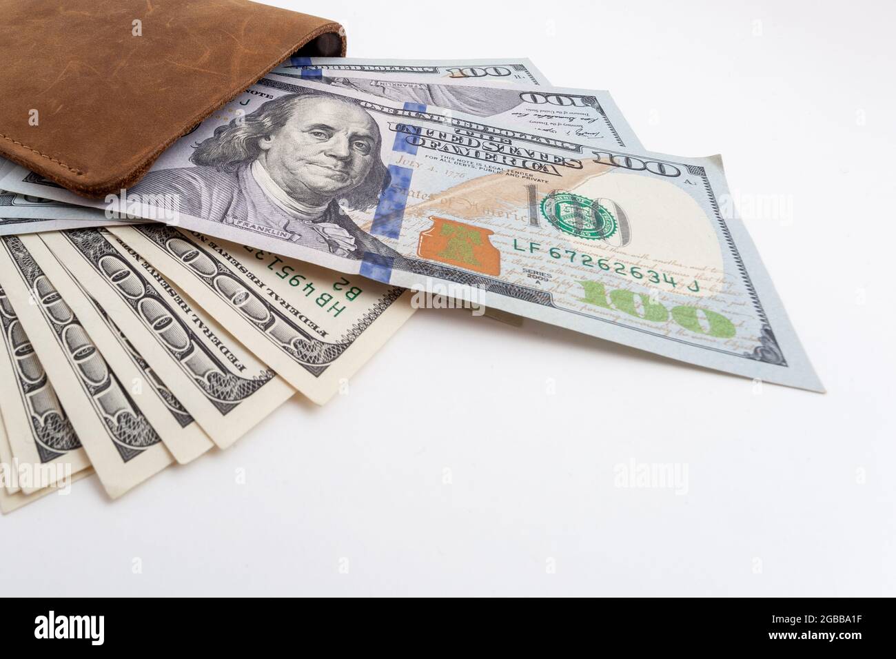 wallet with dollars sticking out of it Stock Photo - Alamy
