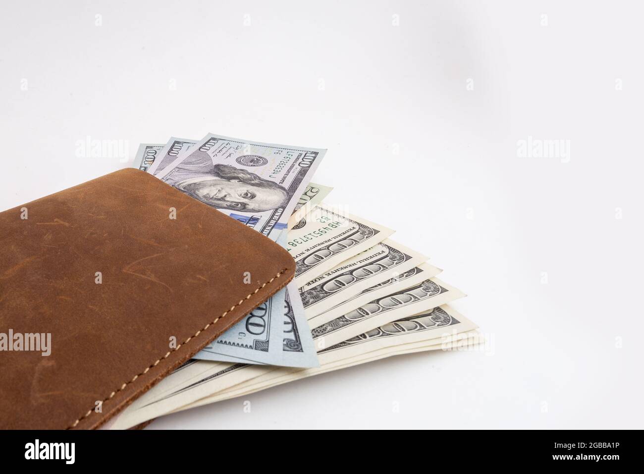 wallet with dollars sticking out of it Stock Photo - Alamy