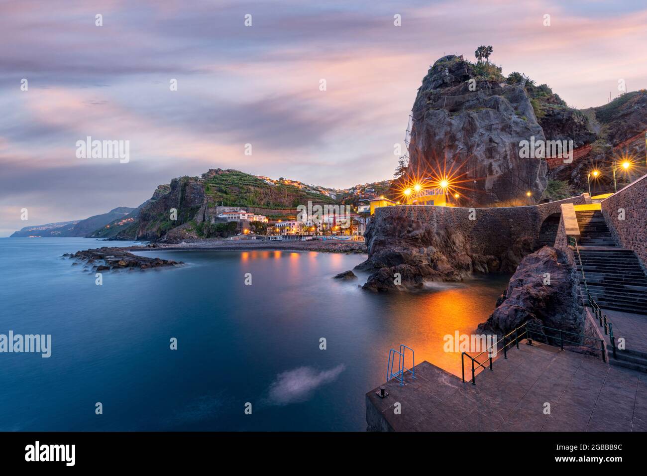 Dusk lights over the seaside town resort of Ponta do Sol washed by the ...