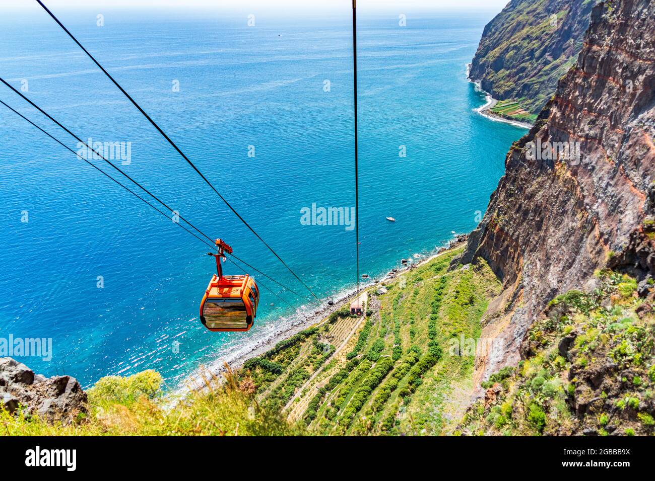 Elevated view of cable car Teleferico Do Rancho going down on steep ...