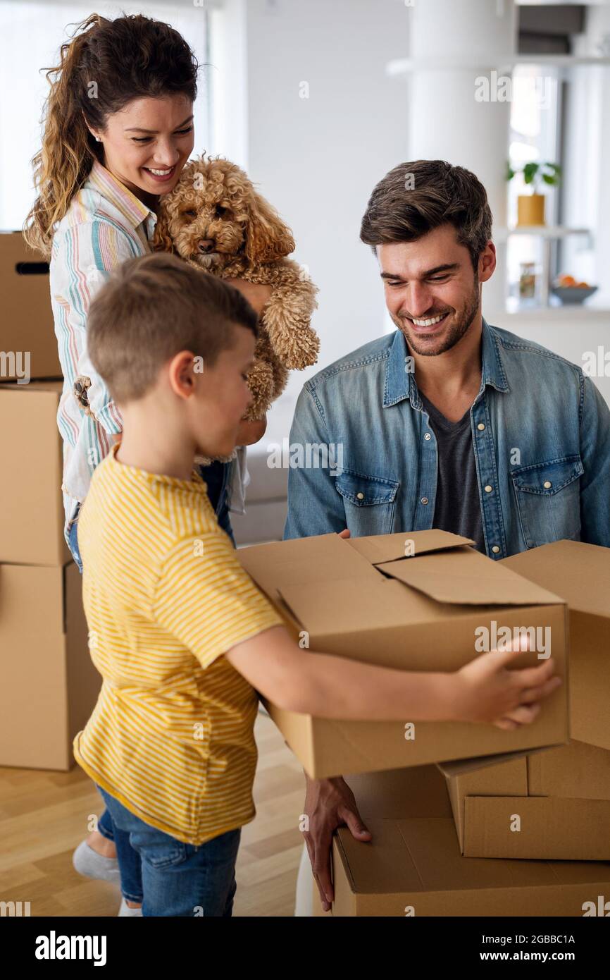 Happy family unpacking boxes in new home on moving day Stock Photo - Alamy