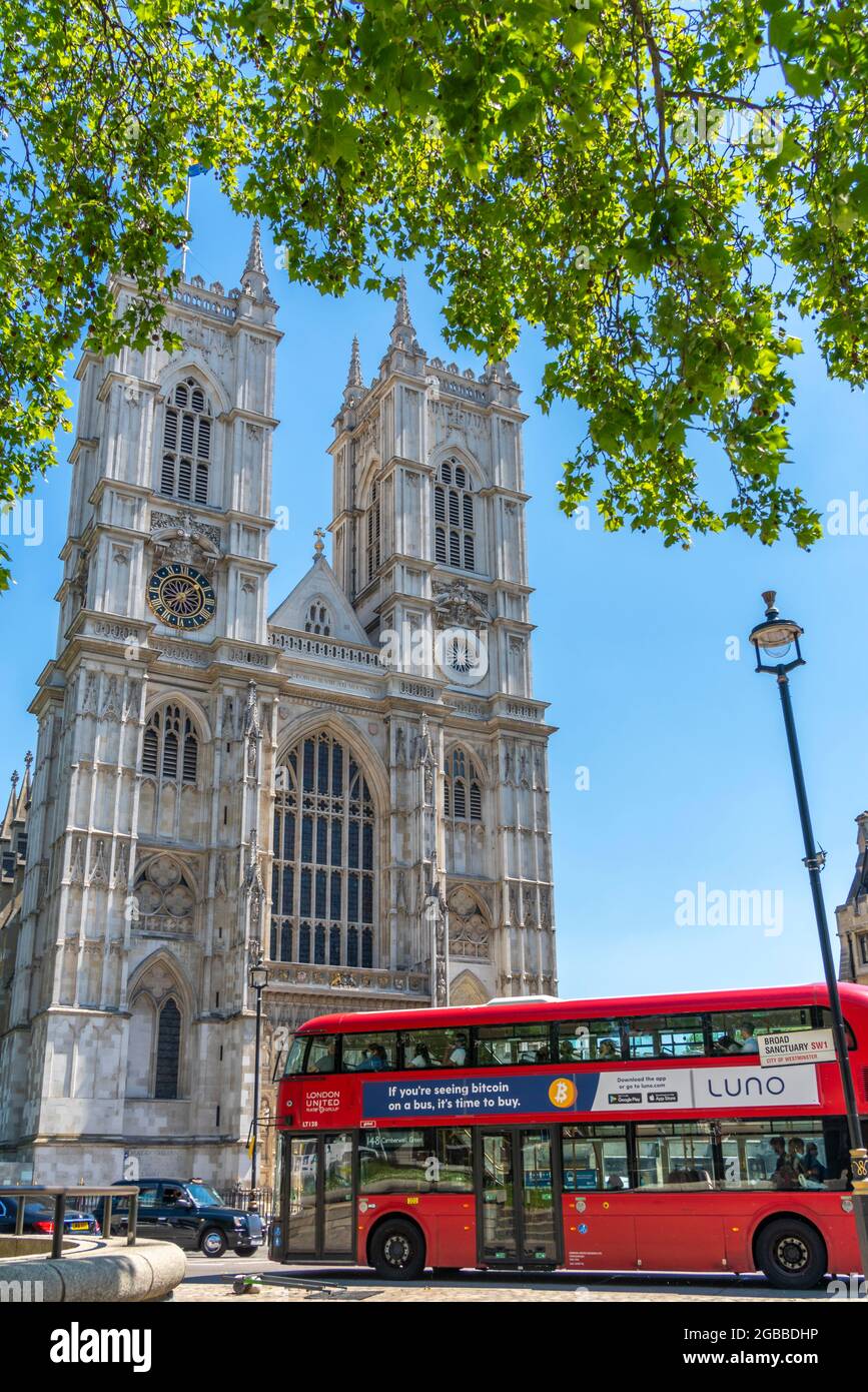 View of traditional red bus and Westminster Cathedral framed by green ...