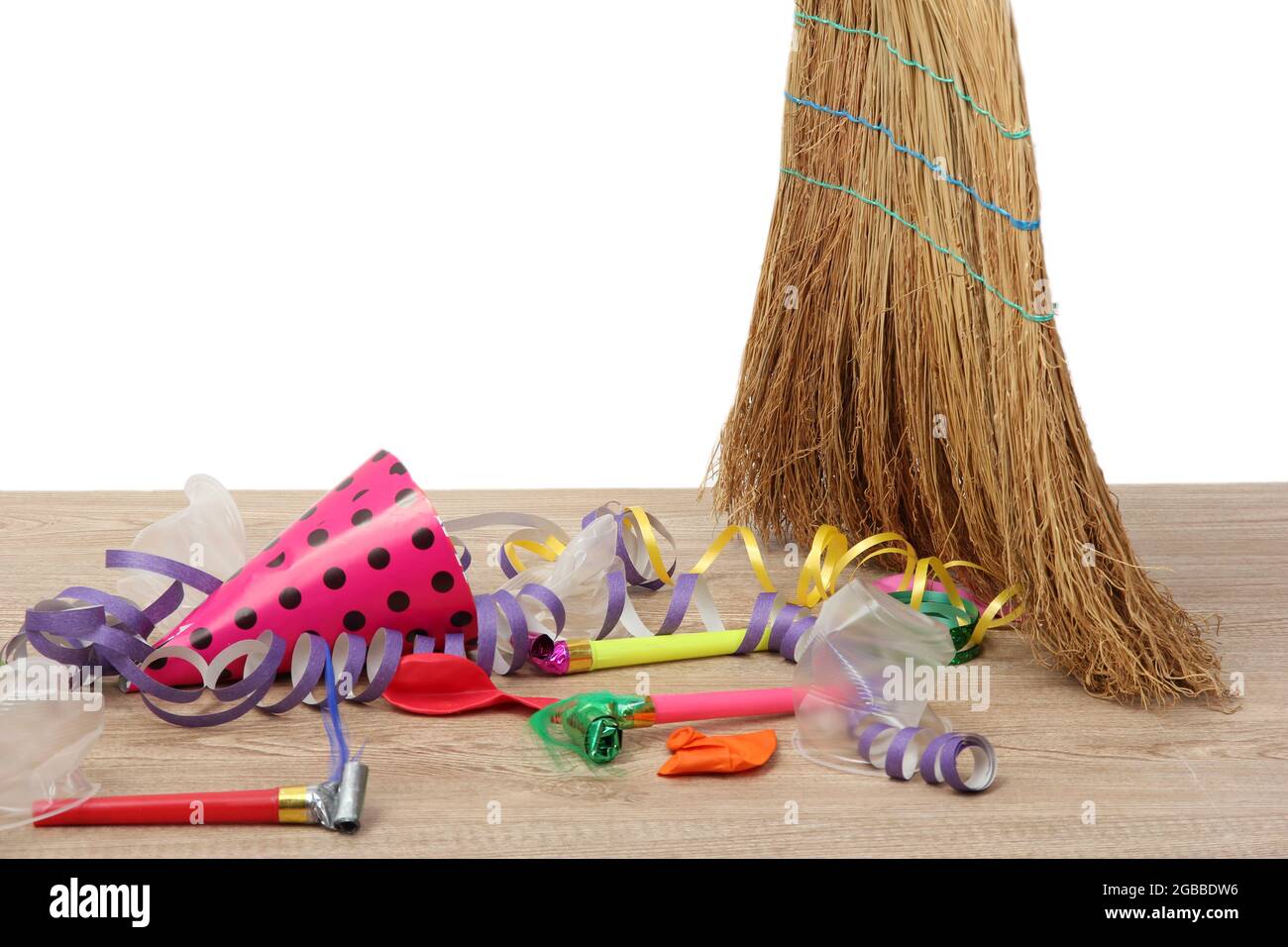 Broom sweep the trash after a party on white background close-up Stock ...