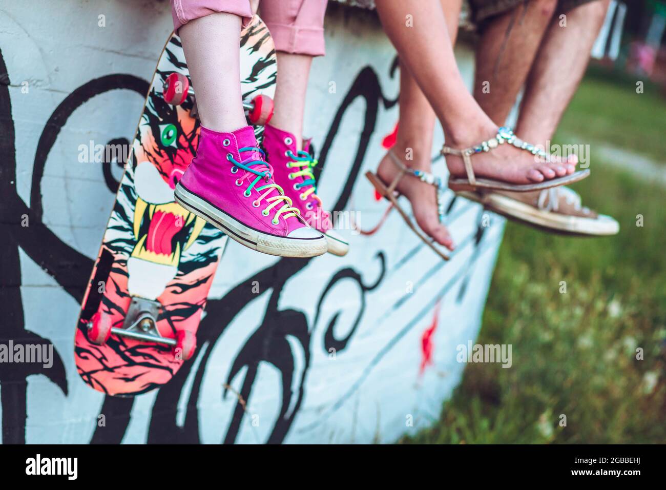 Close-up of teens legs with pink sneakers and skateboard Stock Photo ...