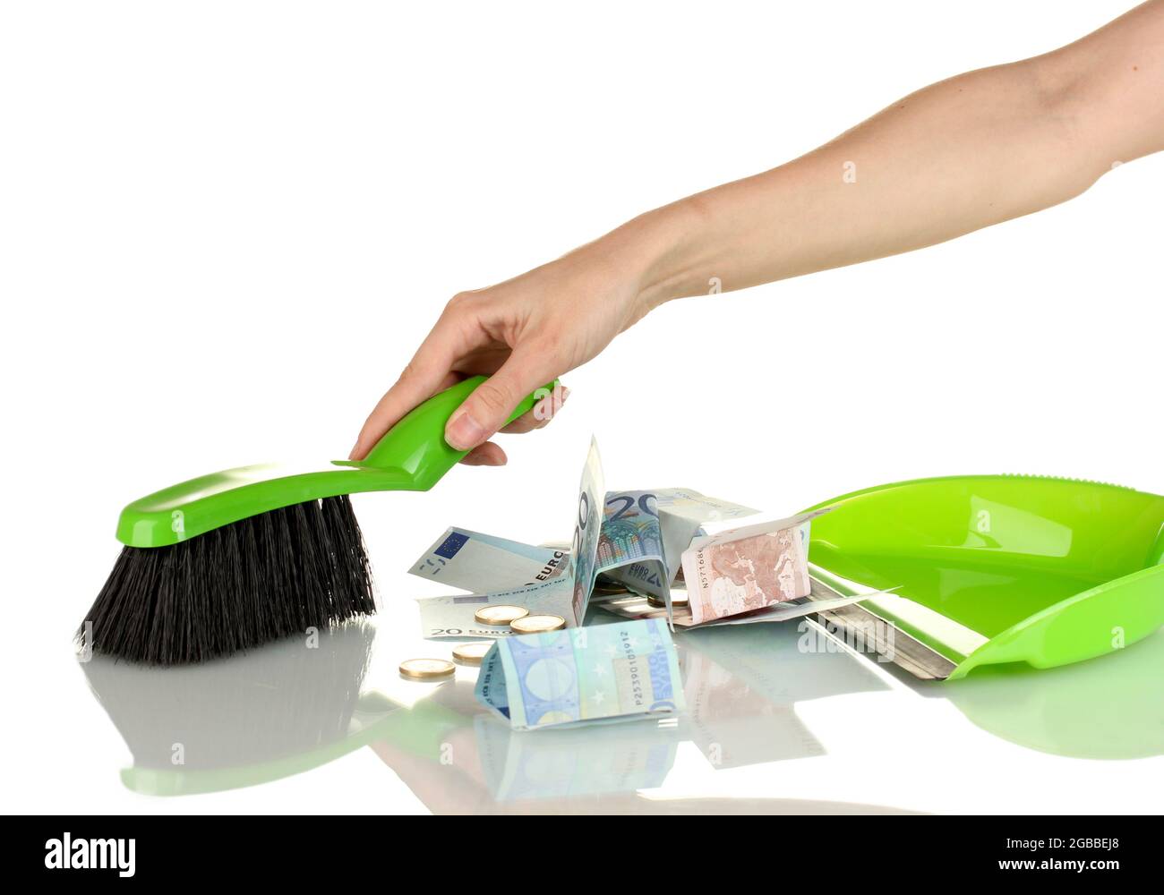 Sweeps money in the shovel on white background close-up Stock Photo - Alamy
