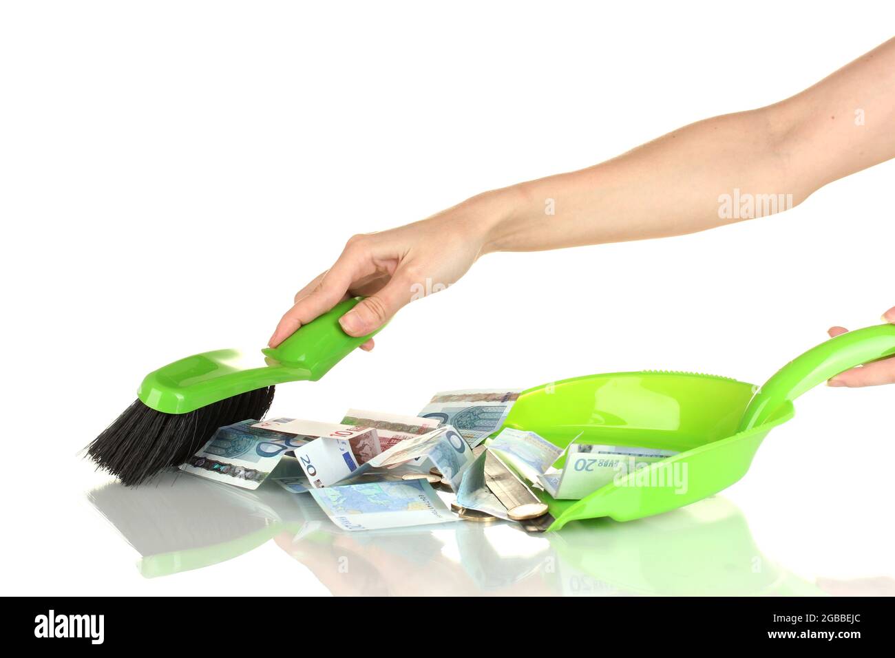 Sweeps money in the shovel on white background close-up Stock Photo - Alamy