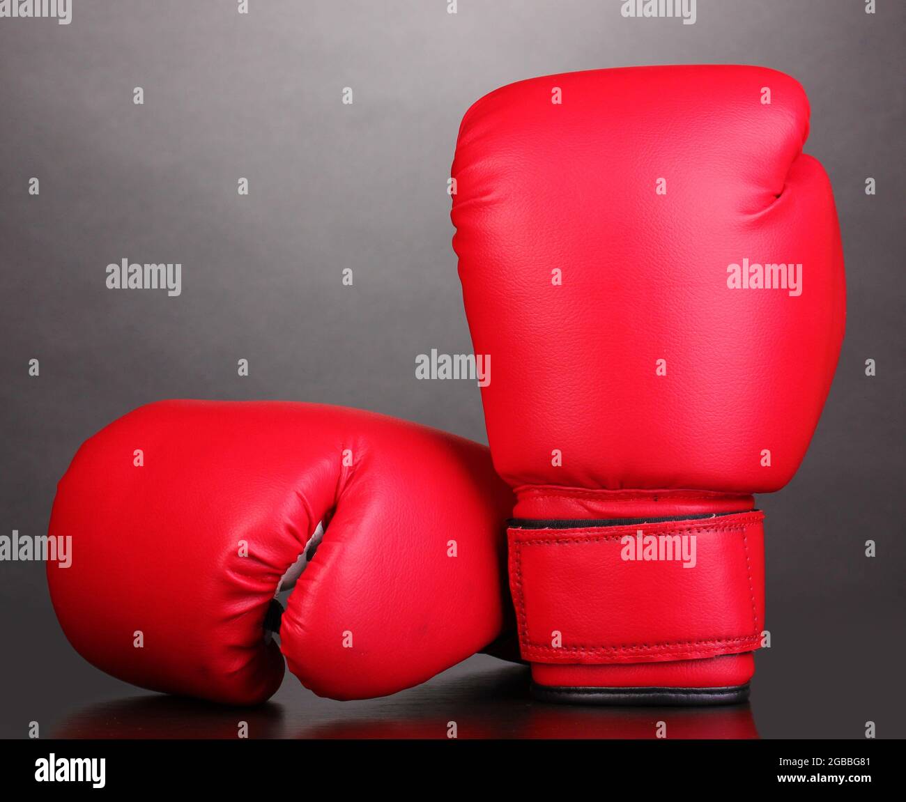 Red boxing gloves on grey background Stock Photo - Alamy