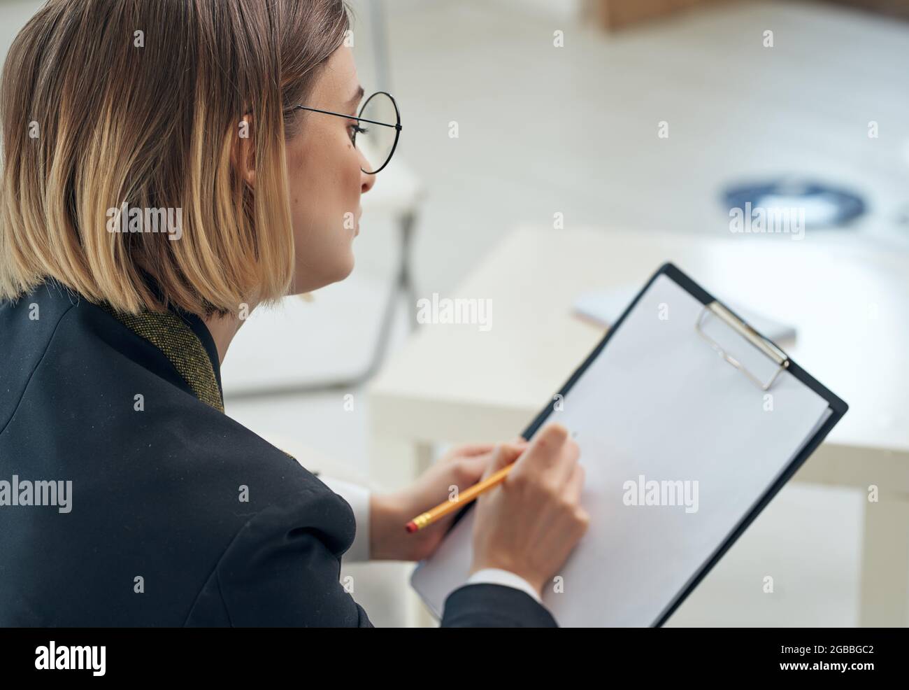 pretty woman sitting in office work recording professionals Stock Photo ...