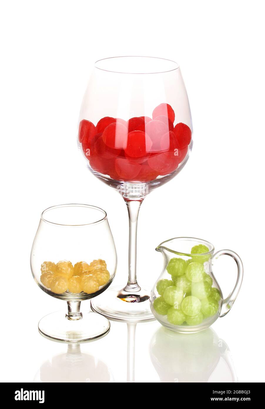 Color candies in glasses isolated on white Stock Photo - Alamy