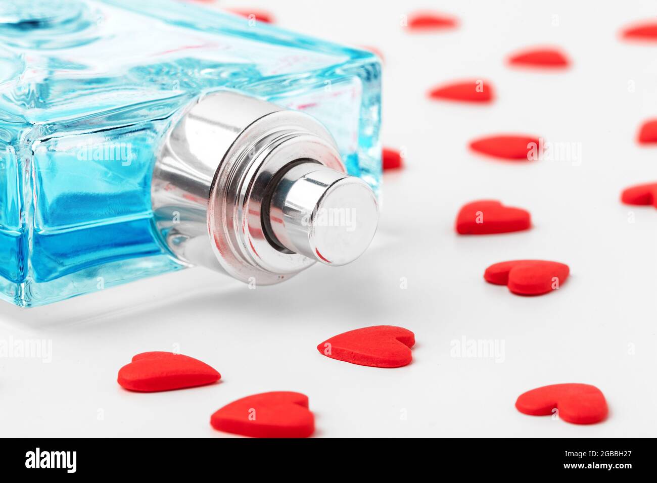 Bottle of perfume with red hearts Stock Photo - Alamy