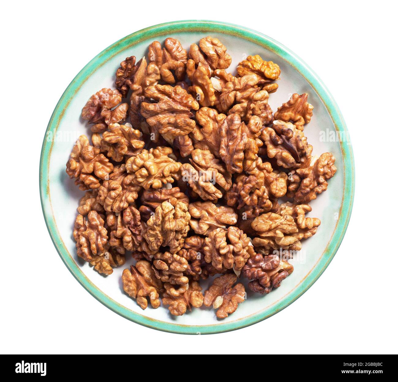 Walnut kernels in green plate isolated on white background, top view ...