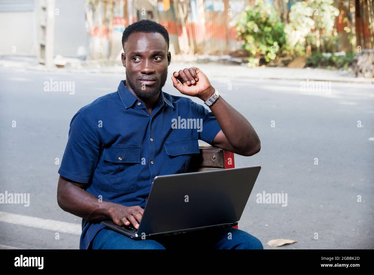 young man sitting outdoors thinking Stock Photo - Alamy