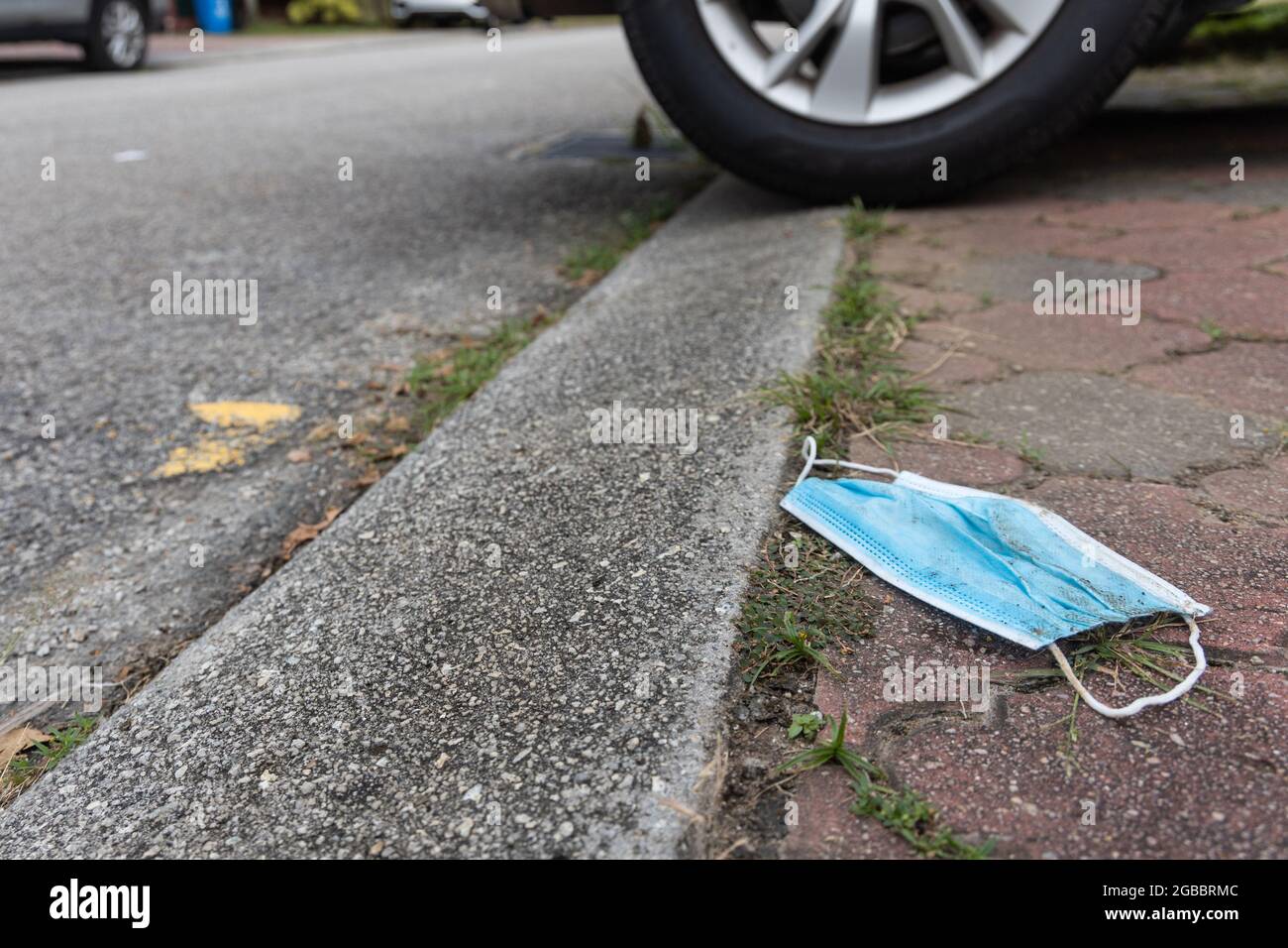 Litter of used surgical face mask with high usage due to covid pandemic ...