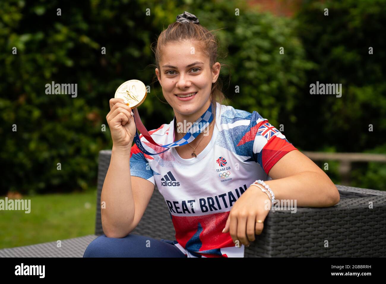 BMX gold medallist Beth Shriever holds up her medal at her home in ...