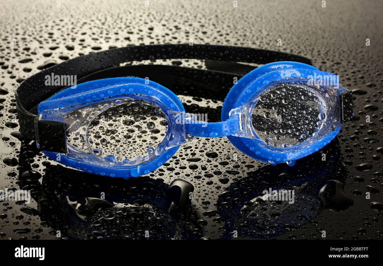 blue swim goggles with drops on grey background Stock Photo - Alamy