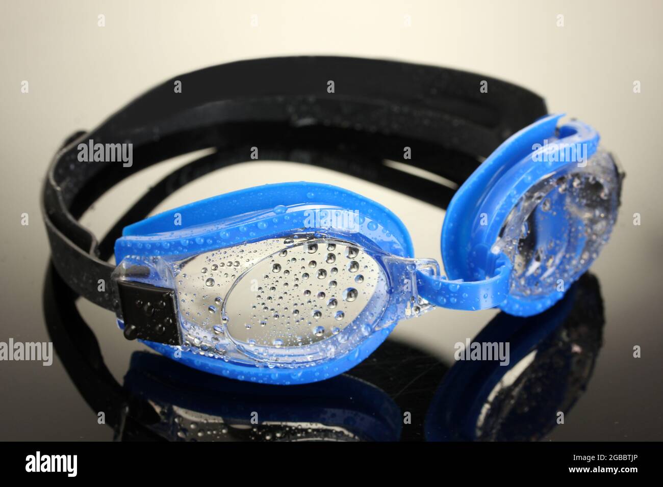 blue swim goggles with drops on grey background Stock Photo - Alamy