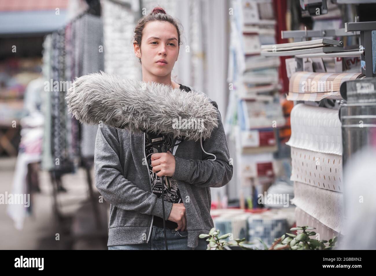 Behind the scene. Sound boom operator resting on the set and hold ...