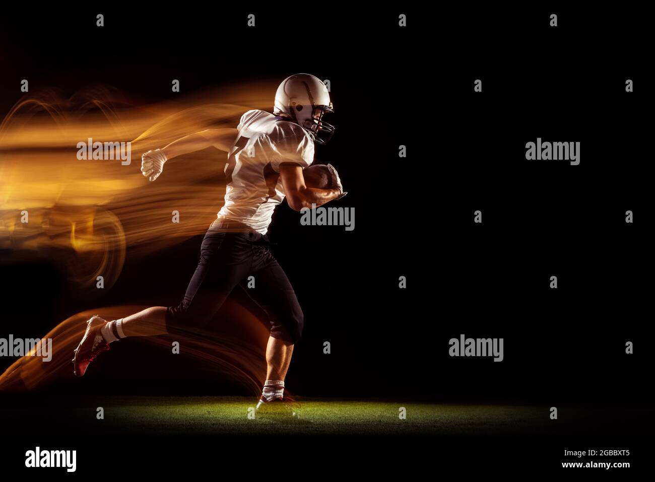 Portrait of young man, American football player training isolated on ...