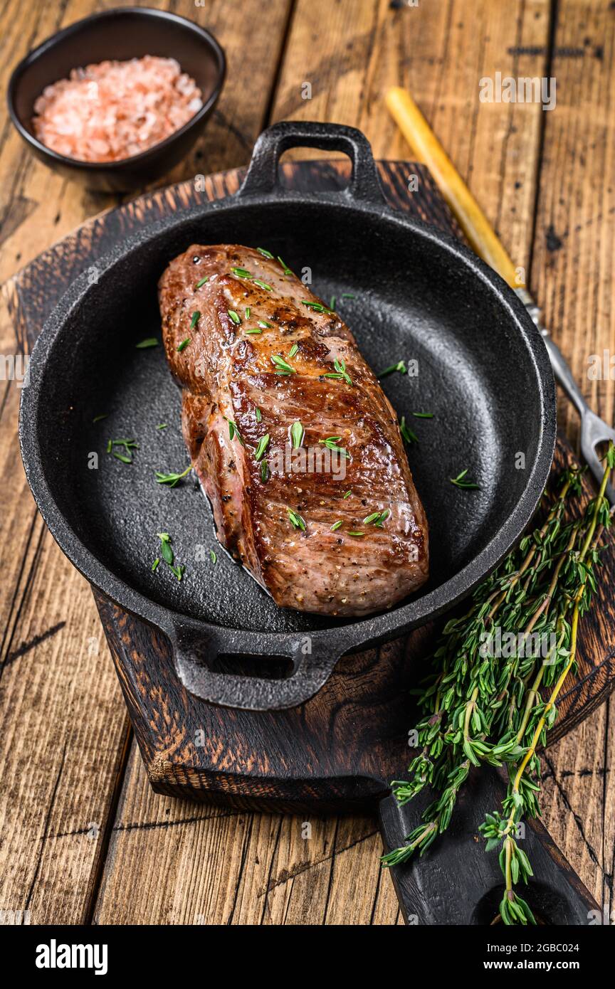 Fried lamb leg meat steak in a pan. wooden background. Top view Stock ...