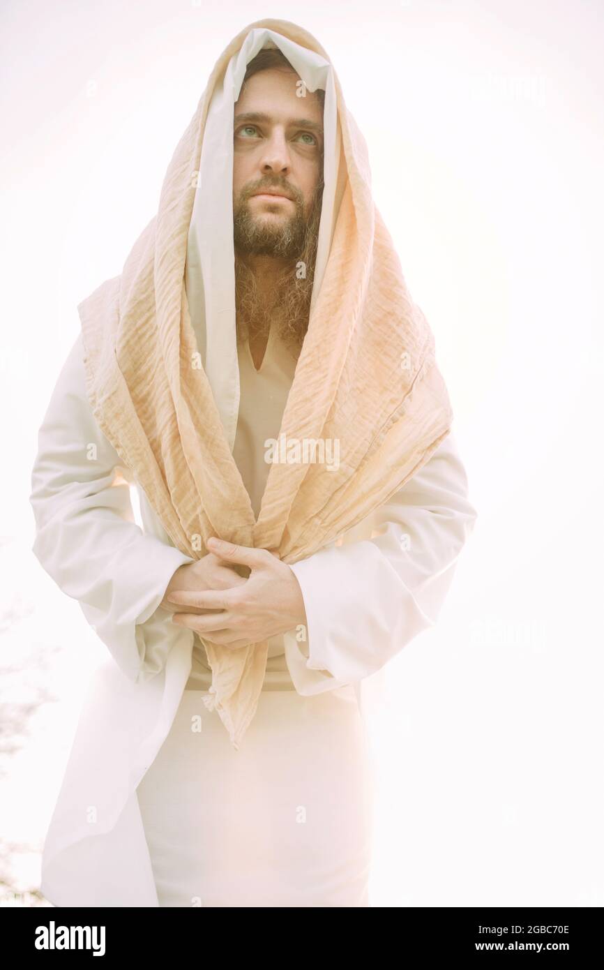 Jesus Christ standing clothed in his traditional white robe against sky ...
