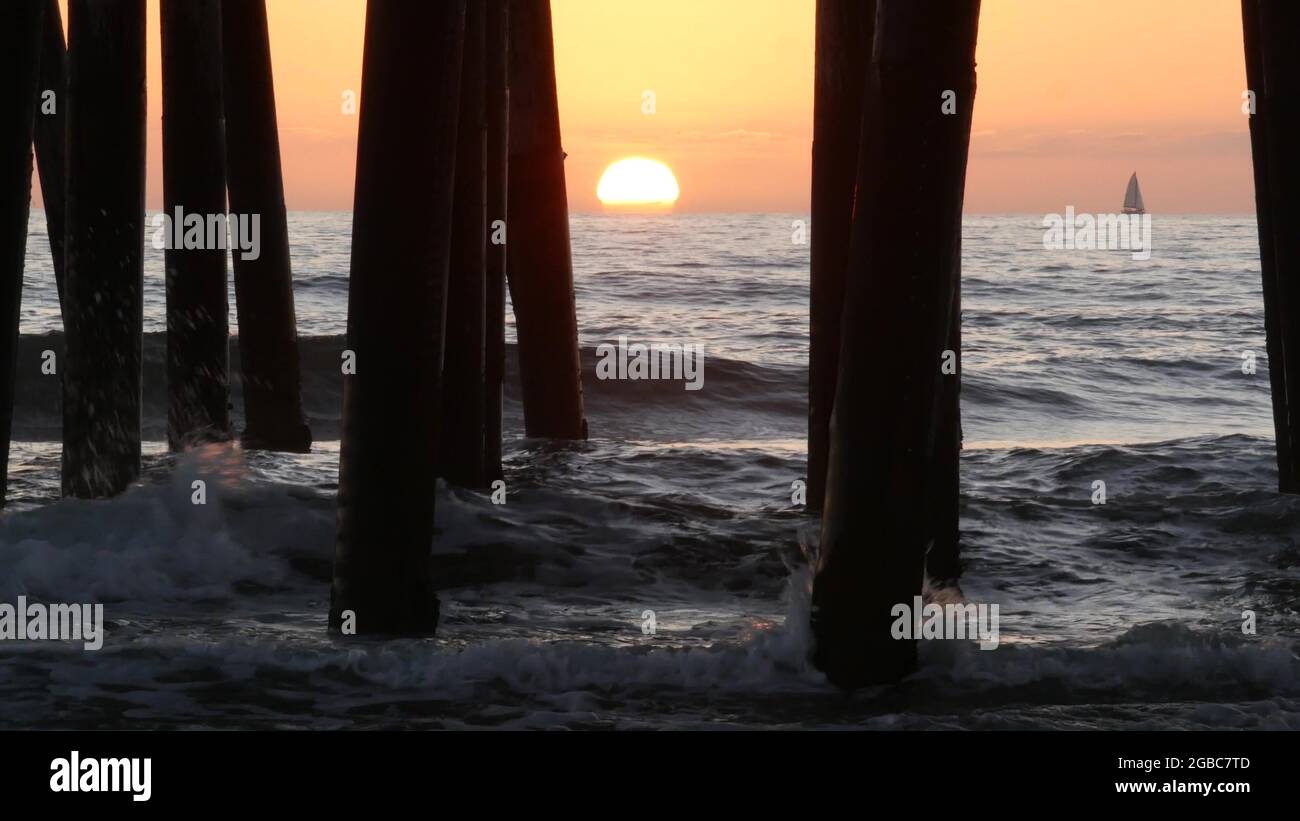 Waves splashing under pier, sunset in Oceanside, California USA. Ocean ...