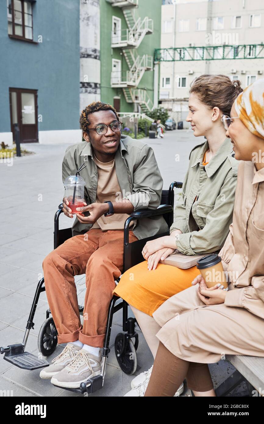 Young African-American handicapped man sitting in wheelchair and ...
