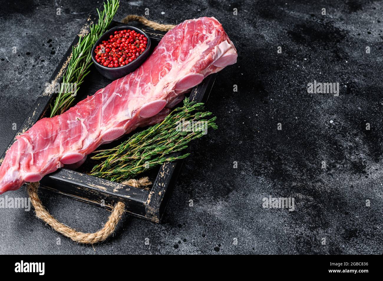 Raw veal calf short spare rib meat with thyme and rosemary. Black ...