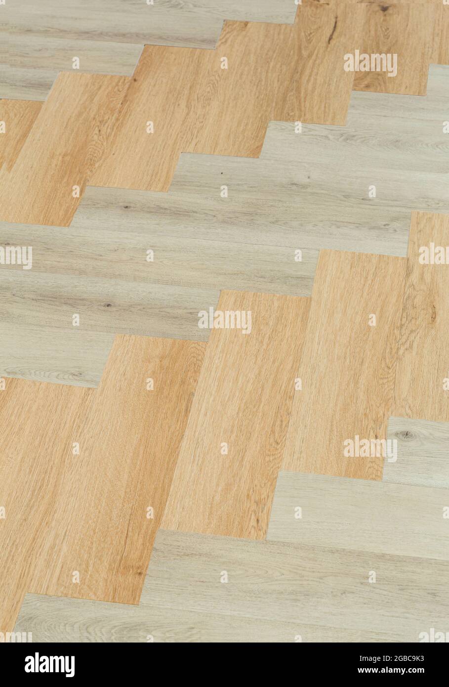 Laminate and parquet with herringbone background. Wooden floor with a ...