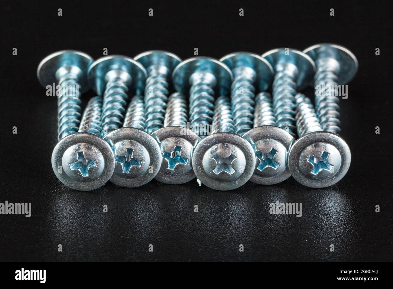 screws on black background Stock Photo - Alamy