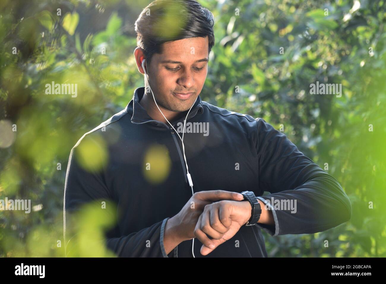 Smiling Man Using Smartwatch and Checking Physical Activity on ...