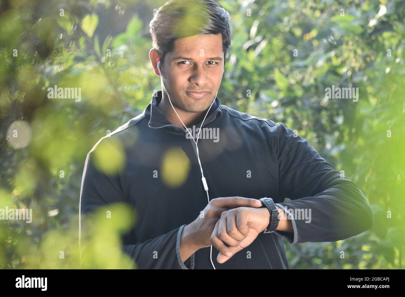 Smiling Man Using Smartwatch and Checking Physical Activity Stock Photo ...