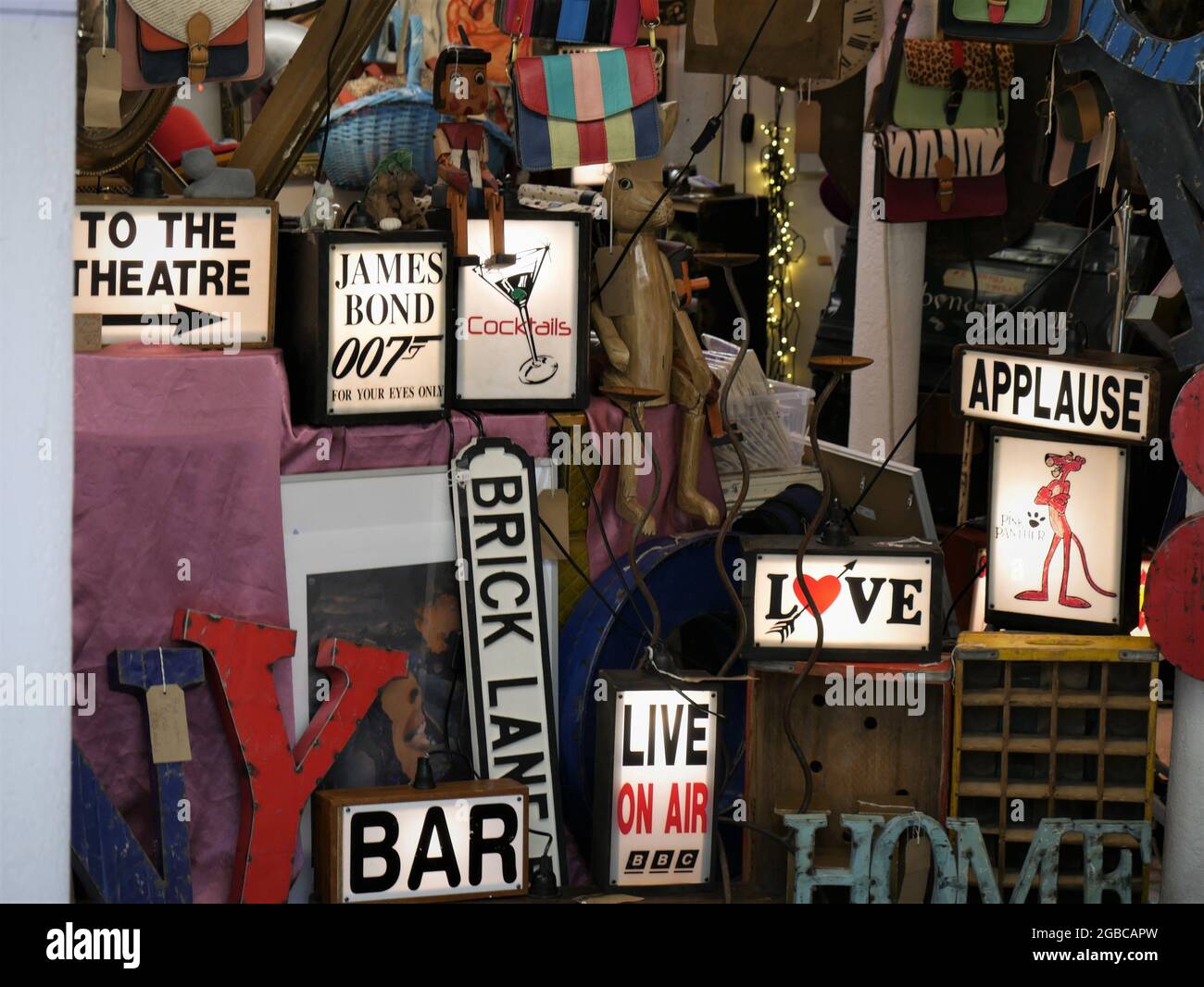 Shop in vintage market selling various illuminated signs Stock Photo ...