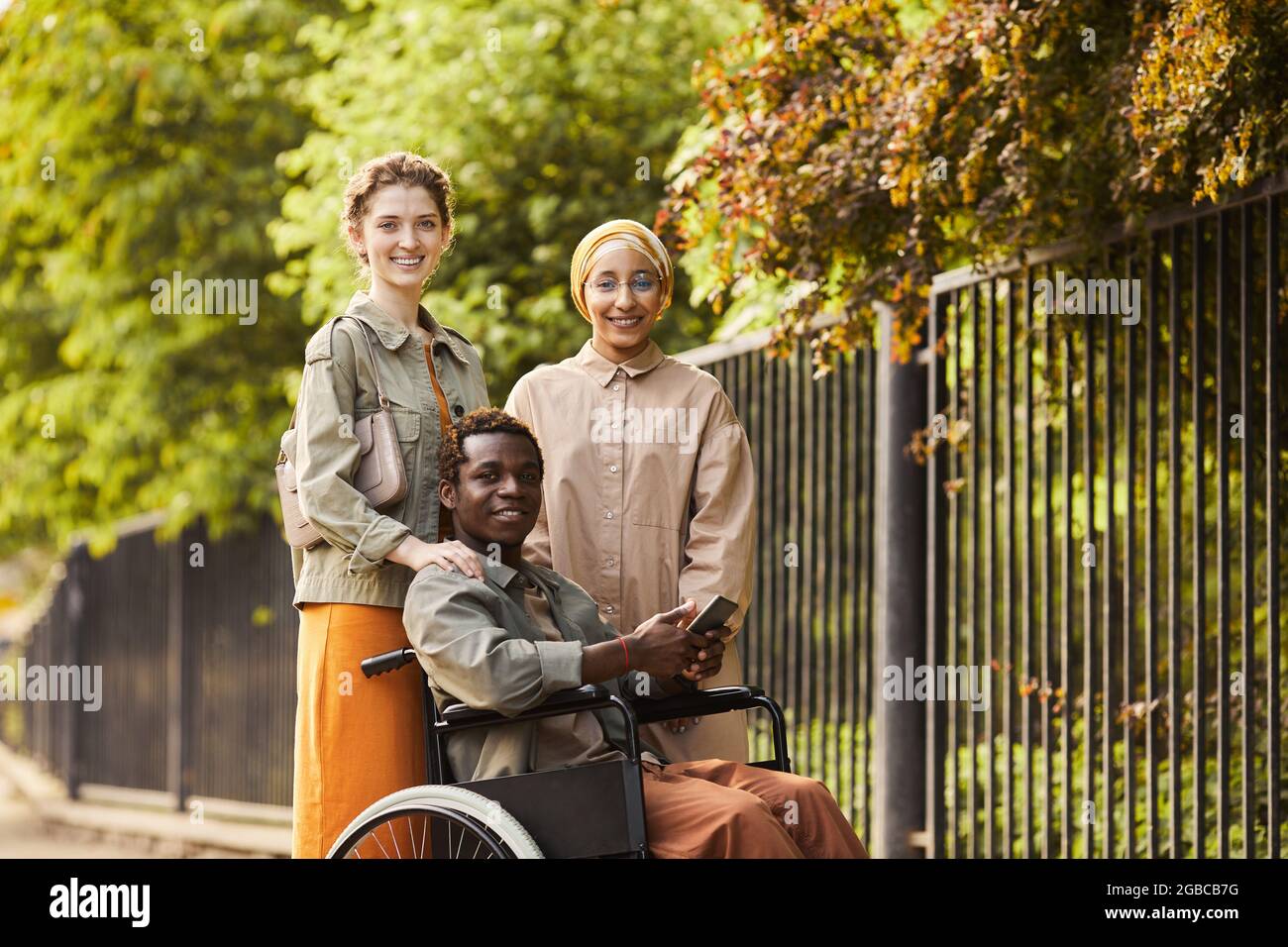 Portrait of happy young multi-ethnic friends including black disabled ...