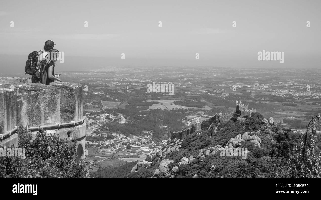 A couple at the edge of Pena Palace enjoying the magnificent top view ...