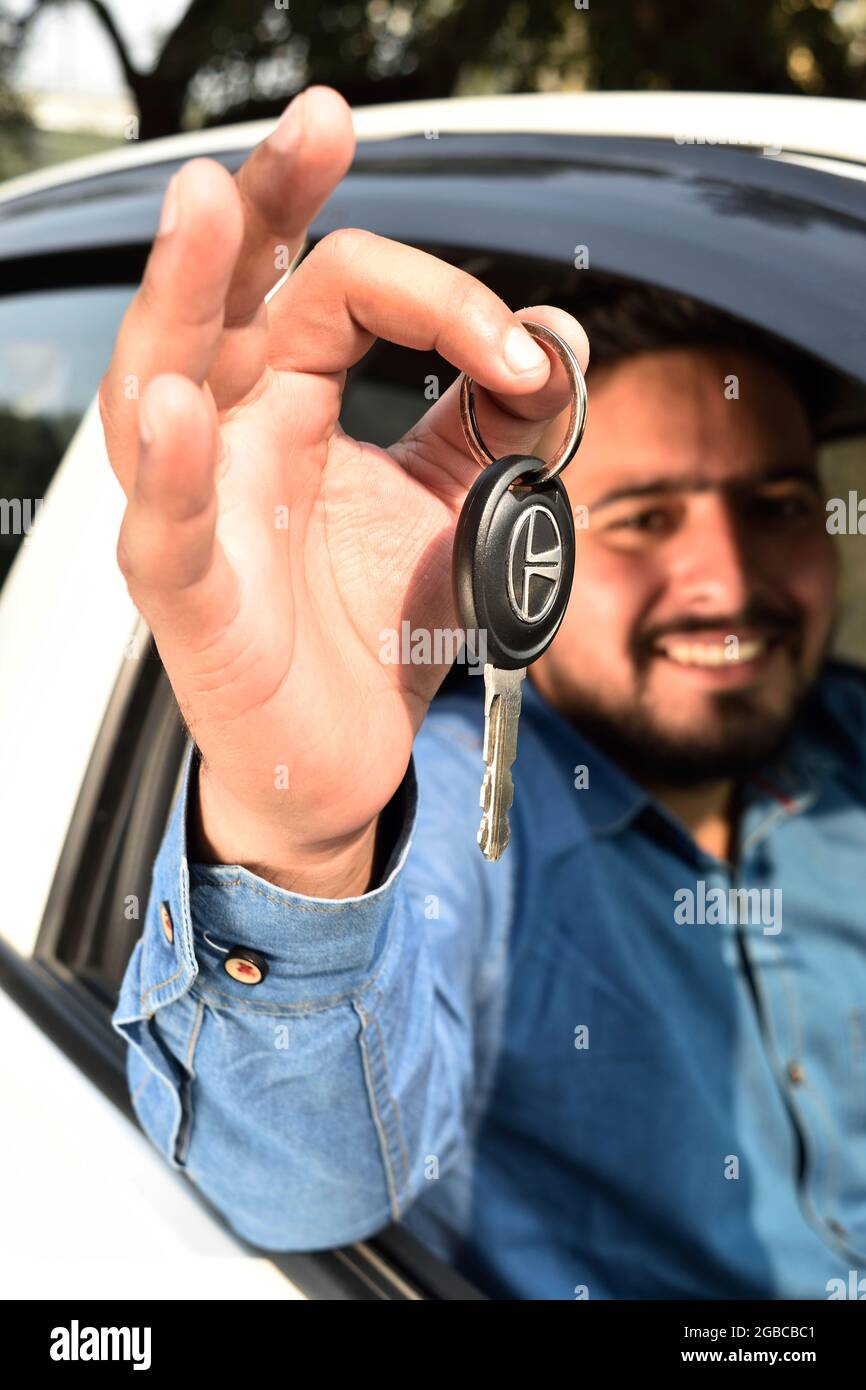 New Delhi, India - December 30, 2017: man showing car key from car ...