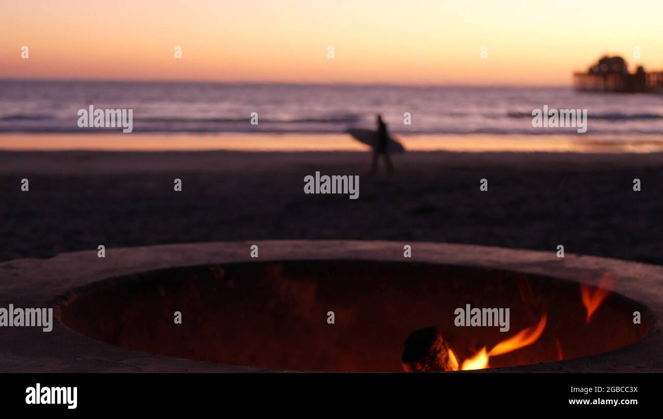 Campfire pit by Oceanside pier, California USA. Camp fire burning on ...