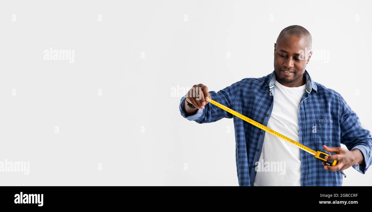 Carpenter Handyman Construction With Tape Line Happy African