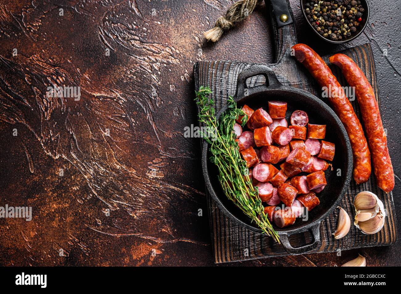 Sliced Hot Smoked sausages with aromatic herbs and spices. Dark ...