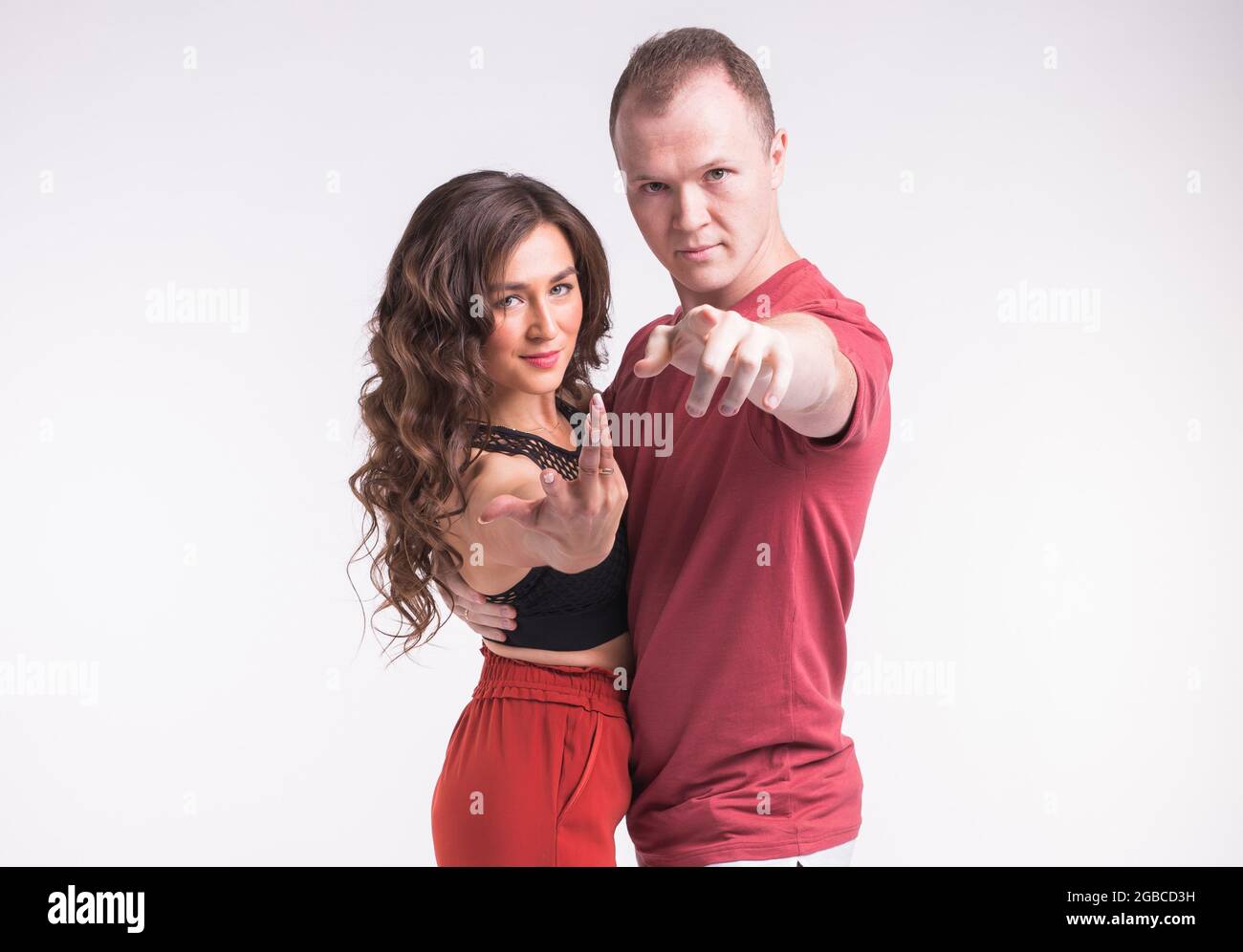 Portrait of young healthy sporty couple hugging on white background ...